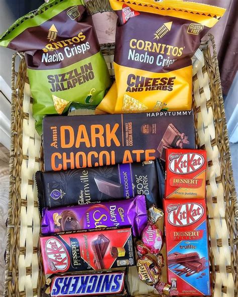 Assorted Chocolates And Candy Bar Wrappers In Wicker Basket Chocolate
