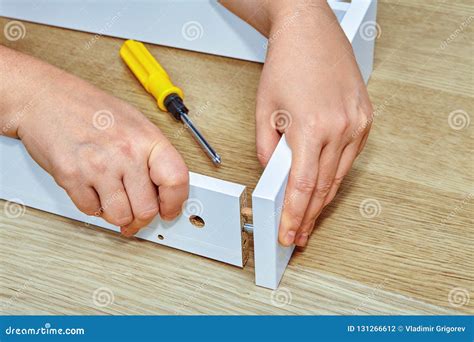 Furniture Assembler Tightens Cam Bolt Fixing Into Furniture Royalty
