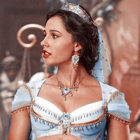 A Woman In A Blue Dress And Tiara