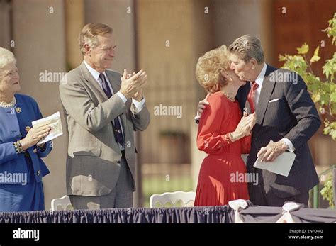 Former President Ronald Reagan Right Gives His Wife Nancy A Kiss At