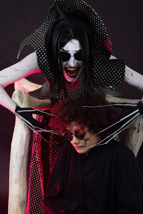 Two People Dressed Up In Costumes And Makeup