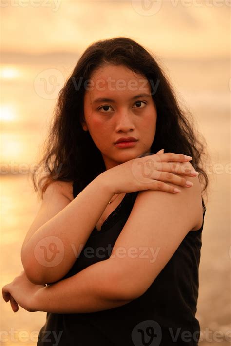 An Asian Woman In A Black Dress And Plump Body Strikes A Very