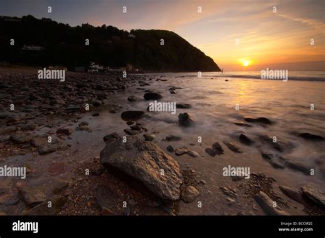 Atmospheric Sunset Over The Rocky Beach At Lynmouth On The North Devon
