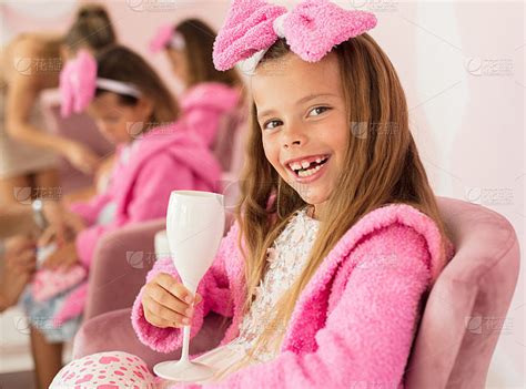 儿童在水疗中心。孩子们在温泉玩得很开心。小女孩喝着饮料，看着镜头。