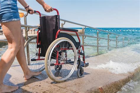 Premium Photo Accessible Beach With Wheelchair With Ramp For Persons With Disability