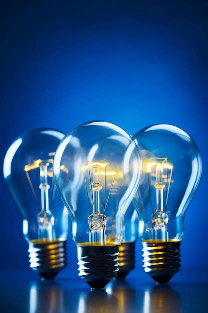 Premium Photo Group Of Three Light Bulbs Sitting On Top Of Table Next