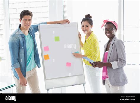 Young Creative Team Brainstorming Together In Creative Office Stock