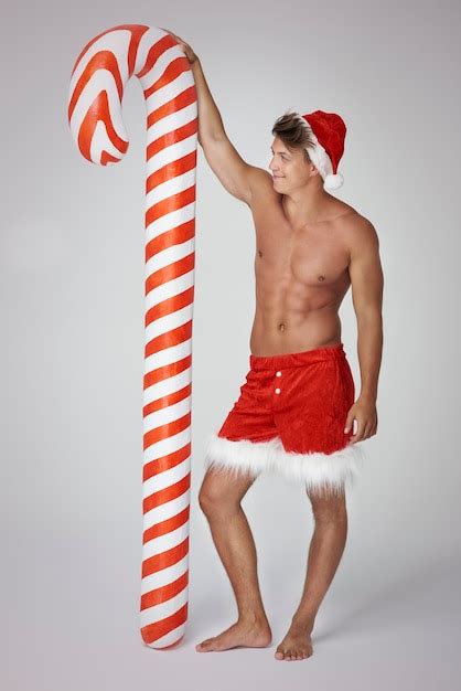 Free Photo Muscular Man And Huge Candy Cane