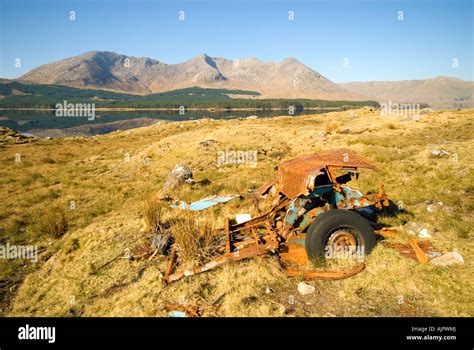 Abandoned Farm Machinery Near Lough Inagh With Bencorr And The Eastern