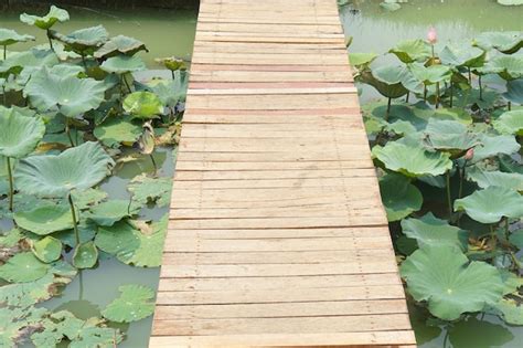 Premium Photo Wooden Floor Walkway In Pond