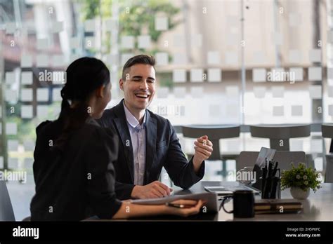 Asian And Caucasian Businesspeople Learn New Business App Apprentice