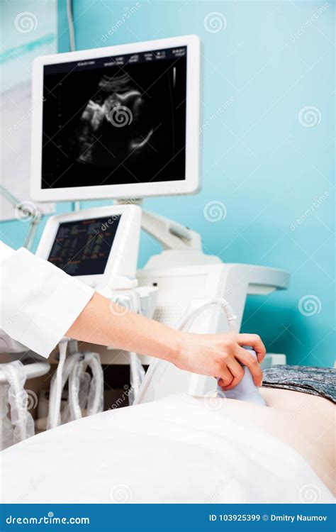 Doctor Performing Obstetric Ultrasonography On A Pregnant Woman Stock