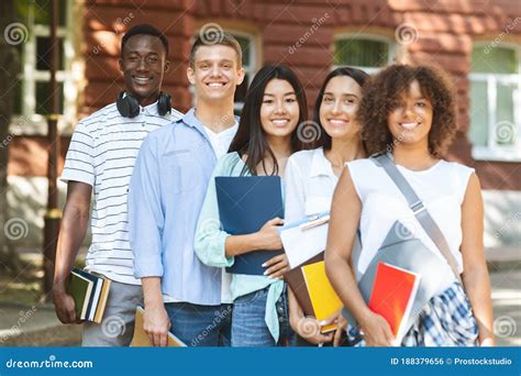 Group Of Smiling Multicultural Students Posing Near University Campus