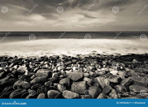 Grayscale Shot Of Stones On The Shore With A Dark Cloudy Sky Stock Image Image Of Summer