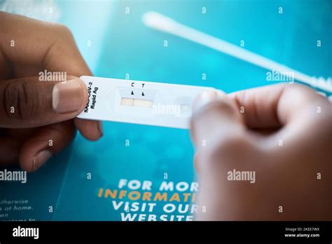 Covid Antigen Test And Hand Of A Patient Looking At Test Results For Coronavirus Illness And