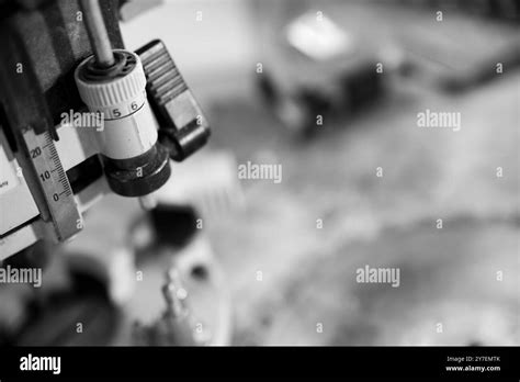 Adjusting The Settings On A Precision Tool In A Workshop With A Shallow Depth Of Field Black