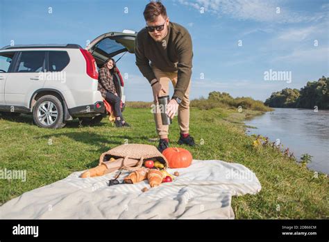 Couple Having Picnic Date At River Beach Stock Photo Alamy