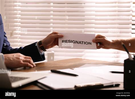 Employee Giving Resignation Letter To Boss In Office Closeup Stock