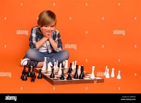 Full Body Photo Of Young Cheerful Boy Sit Floor Hands Touch Cheeks