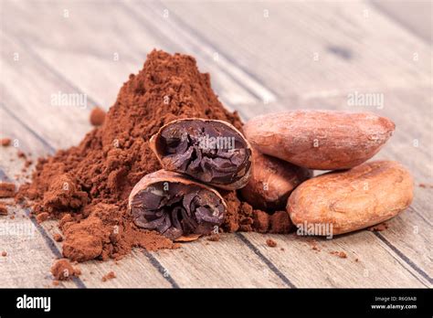 Cocoa Beans And Powder On Wooden Plank Stock Photo Alamy