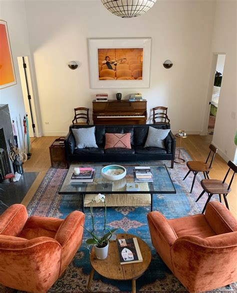 A Living Room With Couches Chairs And A Coffee Table In Its Center
