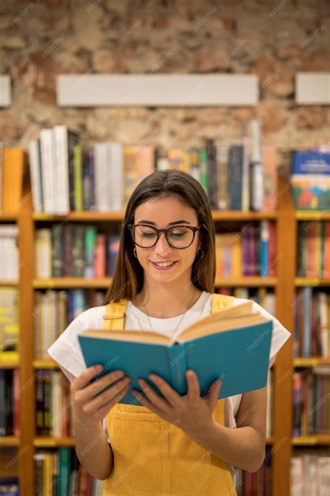 Free Photo Teenage Schoolgirl Looking At Library Book