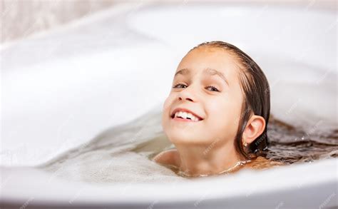 Premium Photo Little Cute Caucasian Girl Bathes In A Bathtub With