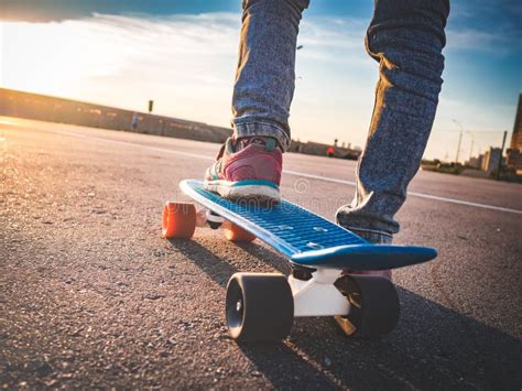 Closeup Of The Feet On The Skateboard On The Pavement Stock Image