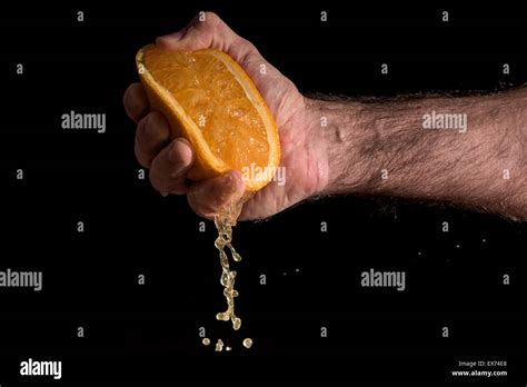 Hand squeezing orange hi-res stock photography and images - Alamy