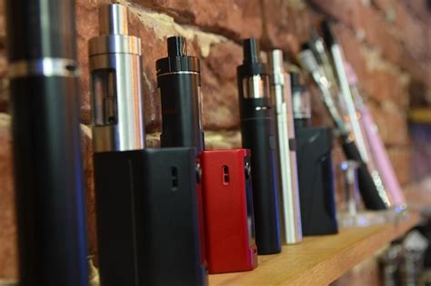 Electronic Cigarette On A Background Of Vape Shop E Cigarette For