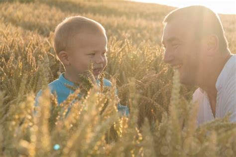 Premium Photo Dad And His Little Son Are Having Fun Walking In A