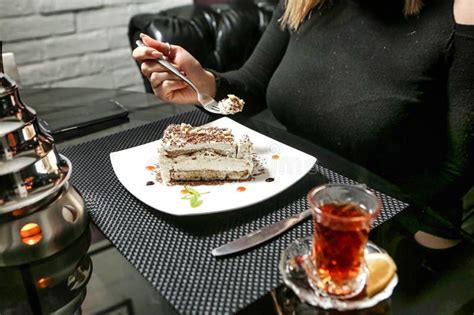 Woman Sitting At Table With A Slice Of Cake Stock Image Image Of