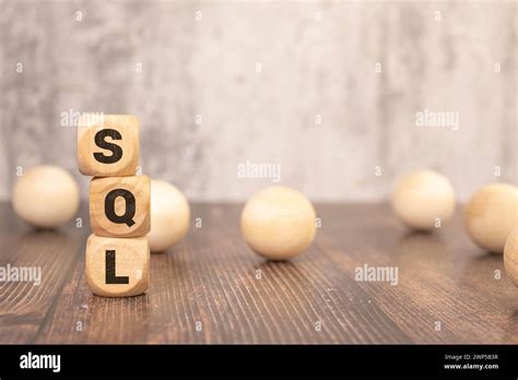 Wooden Cubes On A Brown Background With The Text Sql Represent The Concept Of Sales Qualified
