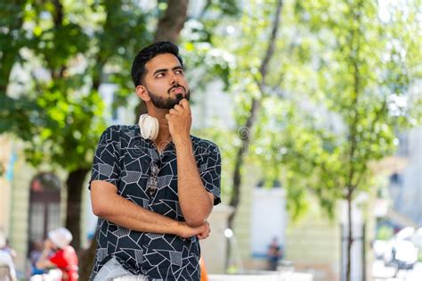 Thoughtful Pensive Puzzled Indian Man With Pensive Expression Pondering A Solution Doubting