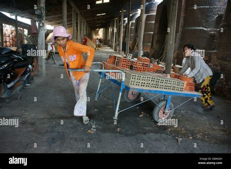 Worker Working At Brick Factory Workwoman In Hard Work Pulling Up The