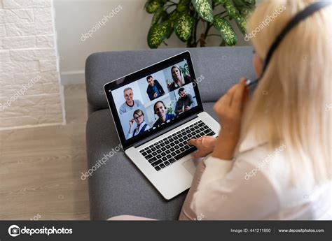 Back View Of Business Woman Talking To Her Colleagues About Plan In
