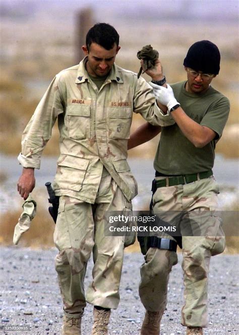 Marine Sgt Adrian Aranda Is Escorted To Medical Care For A Shrapnel