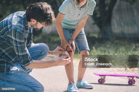 Ayah Berambut Gelap Dalam Kemeja Kotakkotak Meletakkan Plester Menempel