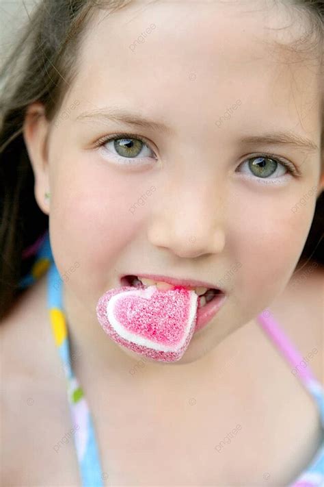 Beautiful Teen Portrait Eating A Candy Heart Bite Female Blue Photo Background And Picture For