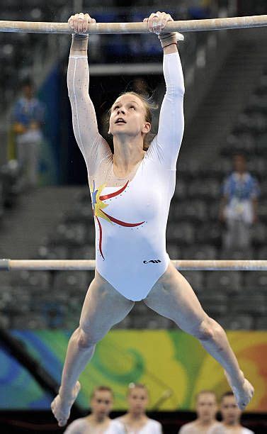 Sandra Izbasa Of Romania Peforms On The Bars During A Practice Artofit
