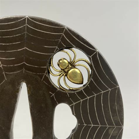 An Elegant Bronze Tsuba Depicting A Spider In Its Web Japanese Circa