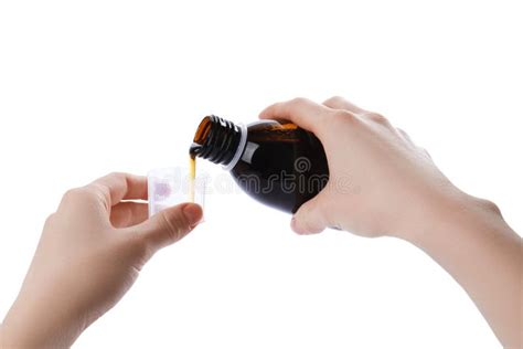 Woman Pouring Syrup Into Measuring Cup From Bottle Isolated On White