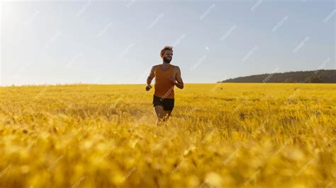 Premium Photo A Man Running In A Field With Yellow Flowers