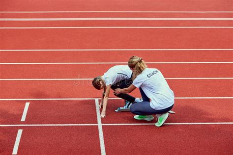 Female Coach Training Athlete Fit Girl Getting Ready To Run On Treadmill At The Stadium Stock