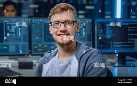 Portrait Of A Smart And Handsome It Specialist Wearing Glasses Smiles Behind Him Personal