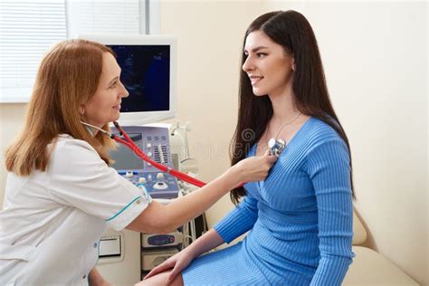 Doctor Listening Stethoscope With To Heart Of Young Female Patient