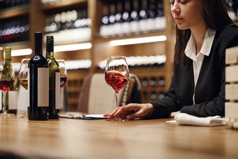 Premium Photo Professional Female Sommelier Swirling And Tasting Red