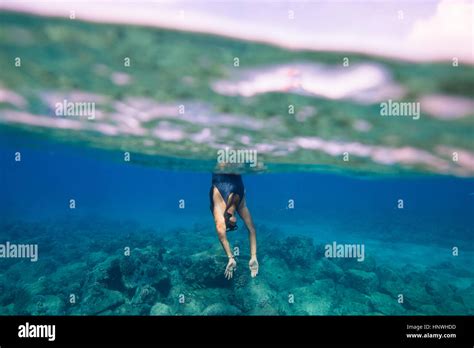 Underwater View Of Woman Diving Into Water Oahu Hawaii Usa Stock