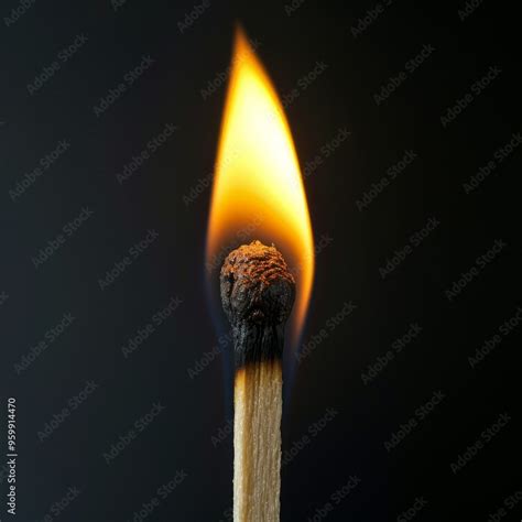 A Close Up Shot Of A Lit Matchstick With A Dark Backdrop The Flame Is