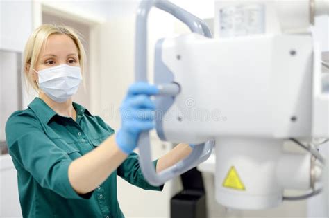 Female Technician Adjusts X Ray Machine Female Radiologist Is Going To Take An Xray Of Patient